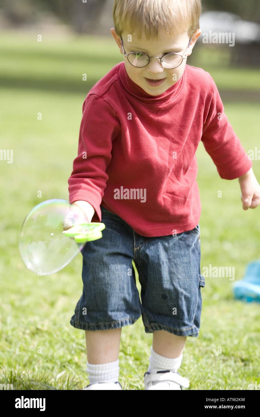Kid plays with bubbles hi-res stock photography and images - Alamy