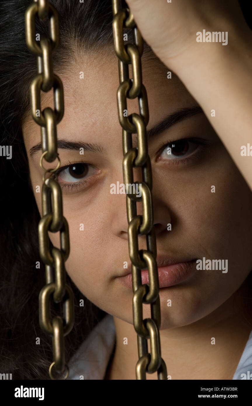 Angry beautiful young Asian woman behind chains Stock Photo - Alamy