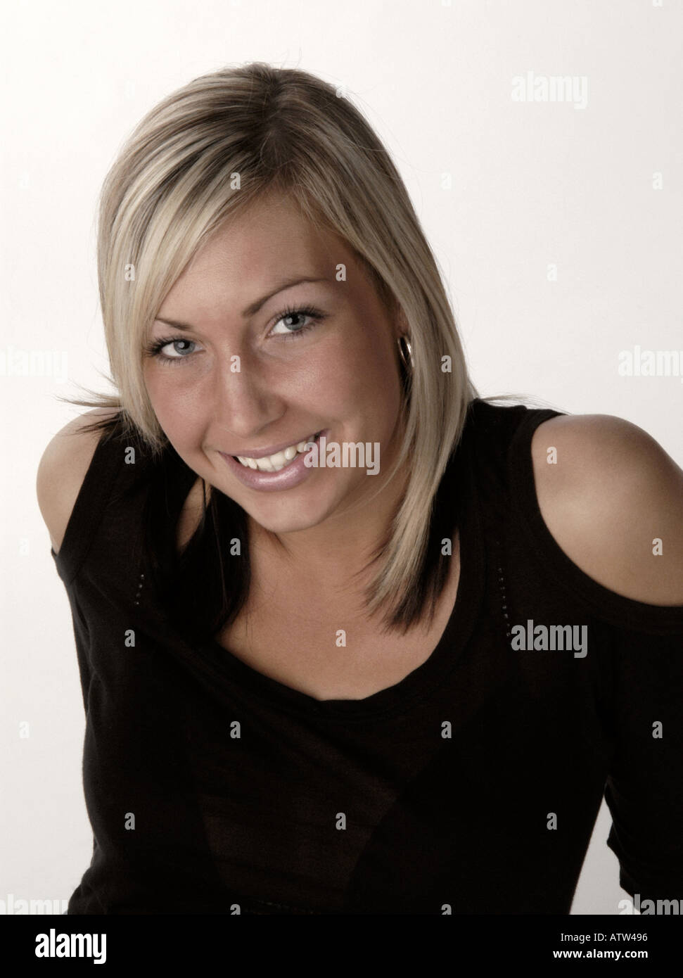 Portrait of young blonde English woman smiling face seated looking up ...
