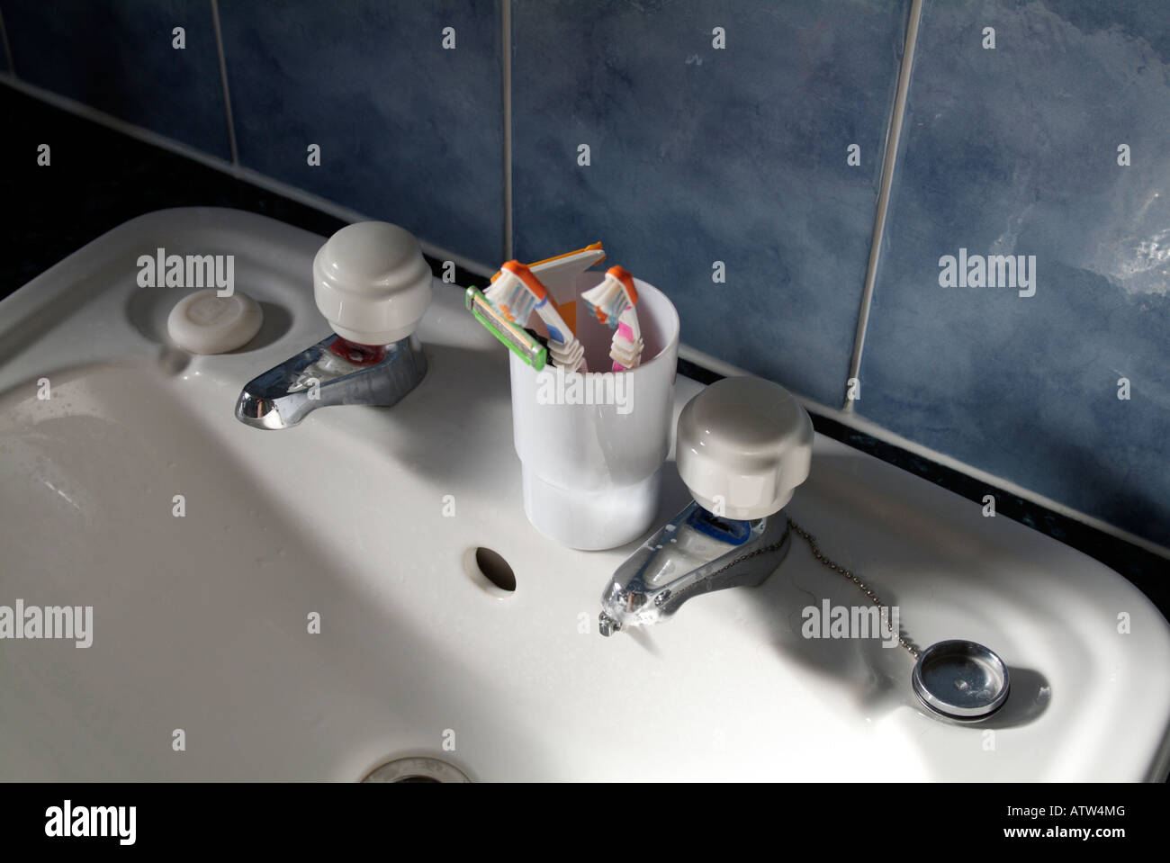 white bathroom washbasin with taps and plug Stock Photo - Alamy