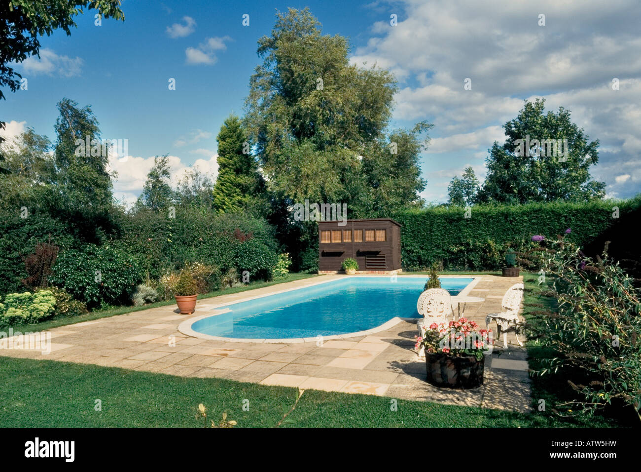 Outdoor swimming pool in garden of house Stock Photo - Alamy