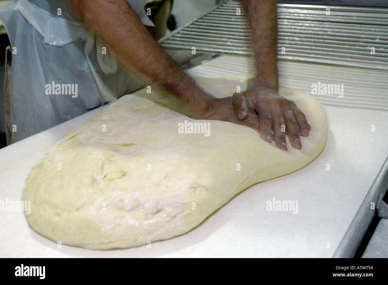 A baker kneads dough in a New York City Dunkin Donuts store Stock Photo ...