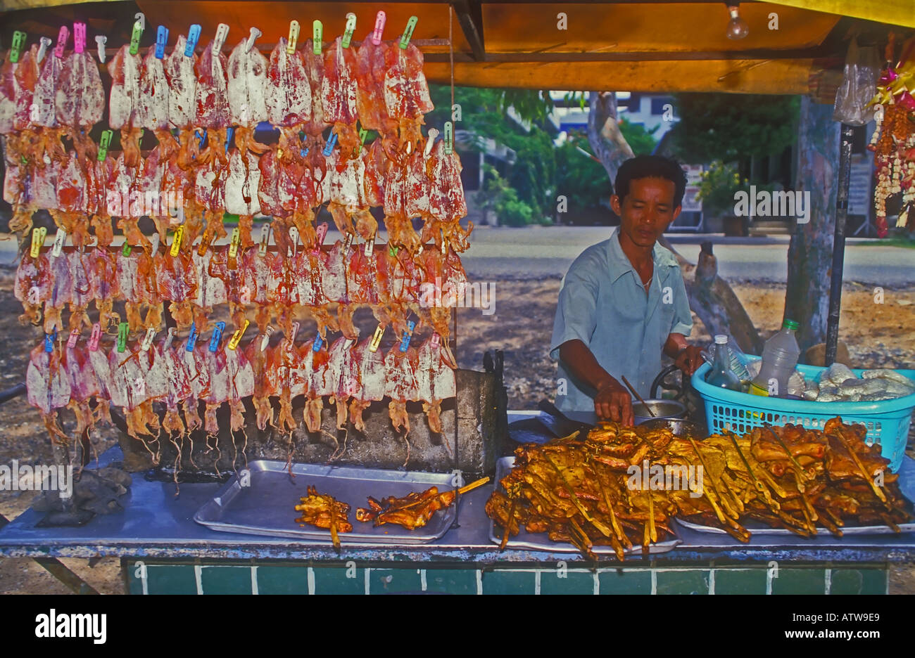 Fast food vendor at his stall in a street market at Pattaya Thailand ...