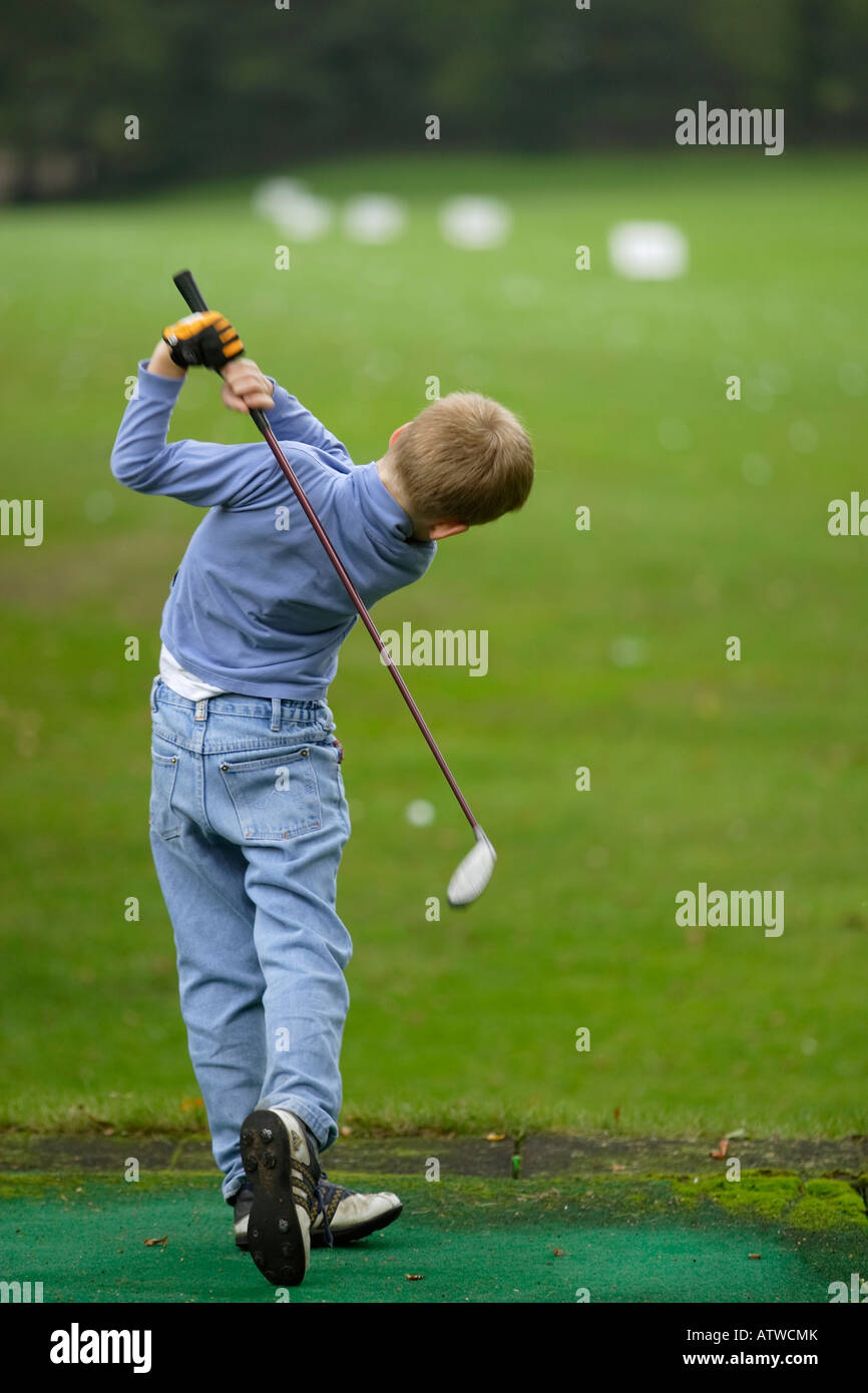 boy golf driving range Stock Photo - Alamy