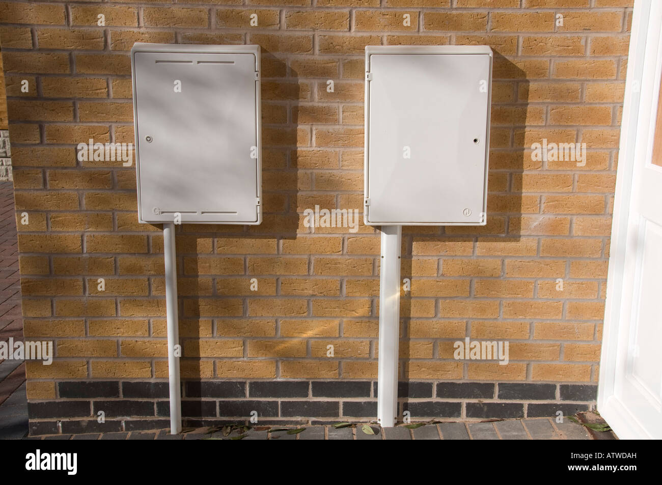 Gas and electricity boxes on wall outside front door Stock Photo - Alamy
