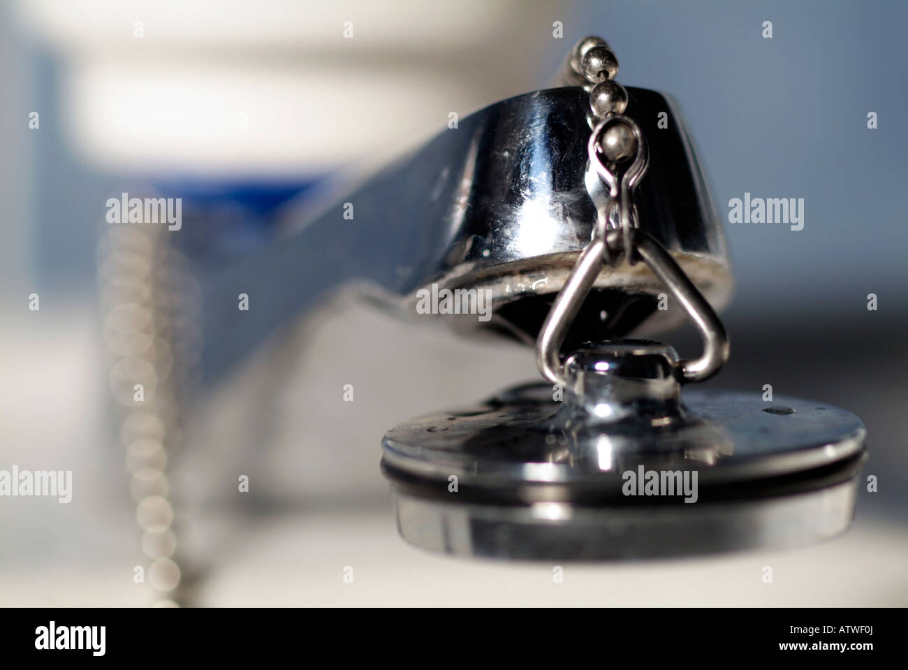 bath plug hanging from chain on bathroom tap Stock Photo - Alamy