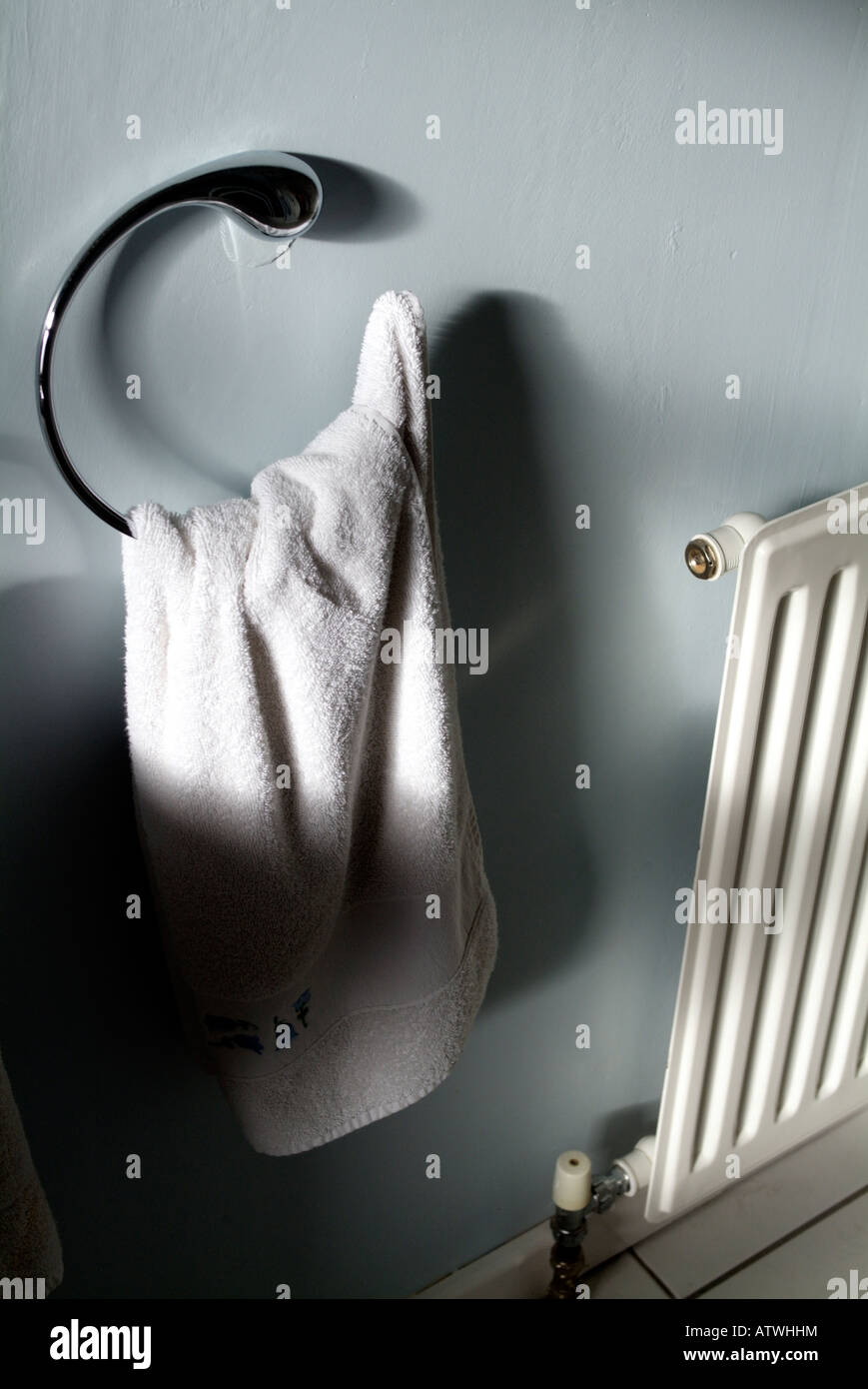 cotton towel hanging beside radiator in bathroom Stock Photo - Alamy
