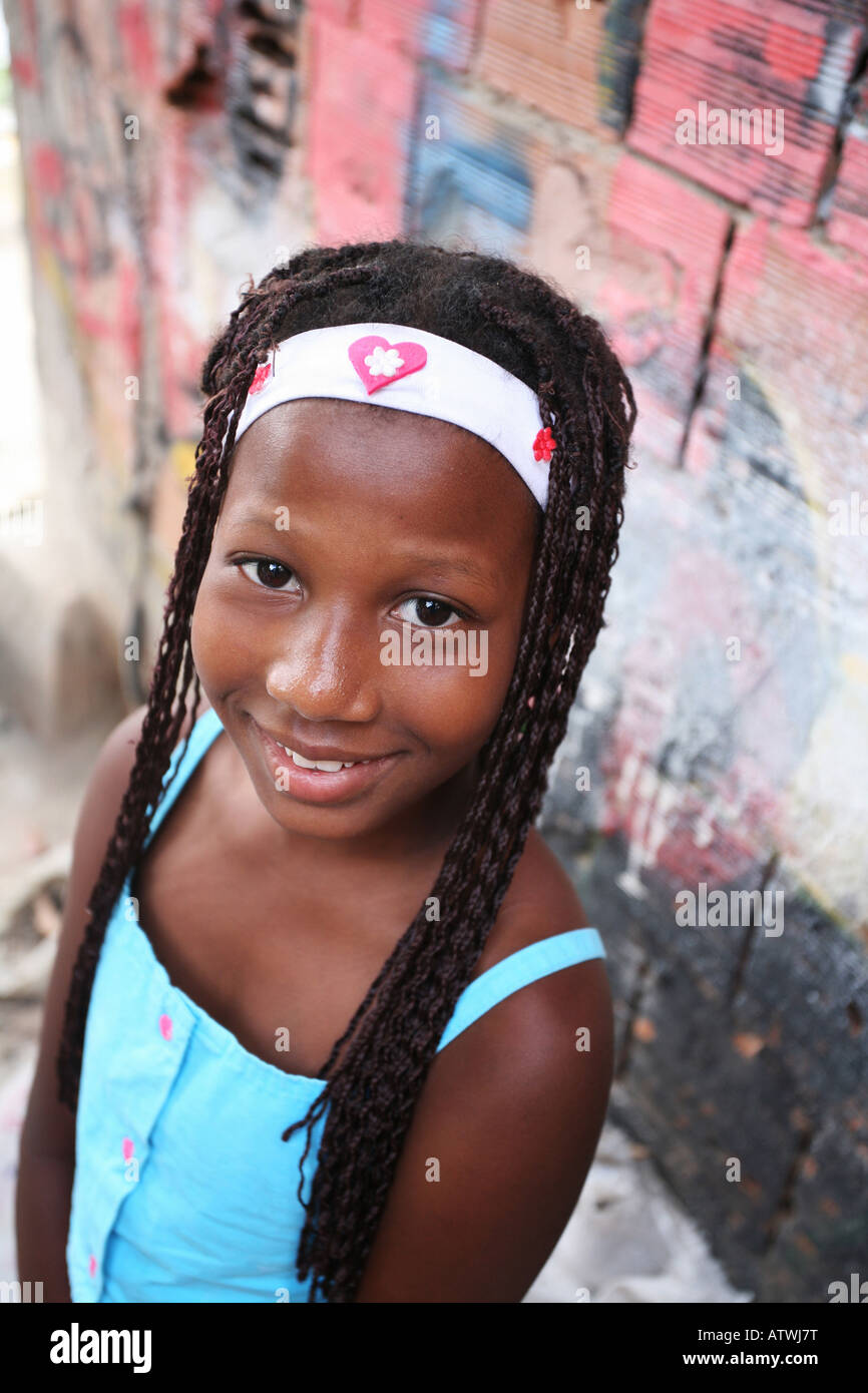 Beautiful girl child in favela urban dereliction smiling in welcome ...