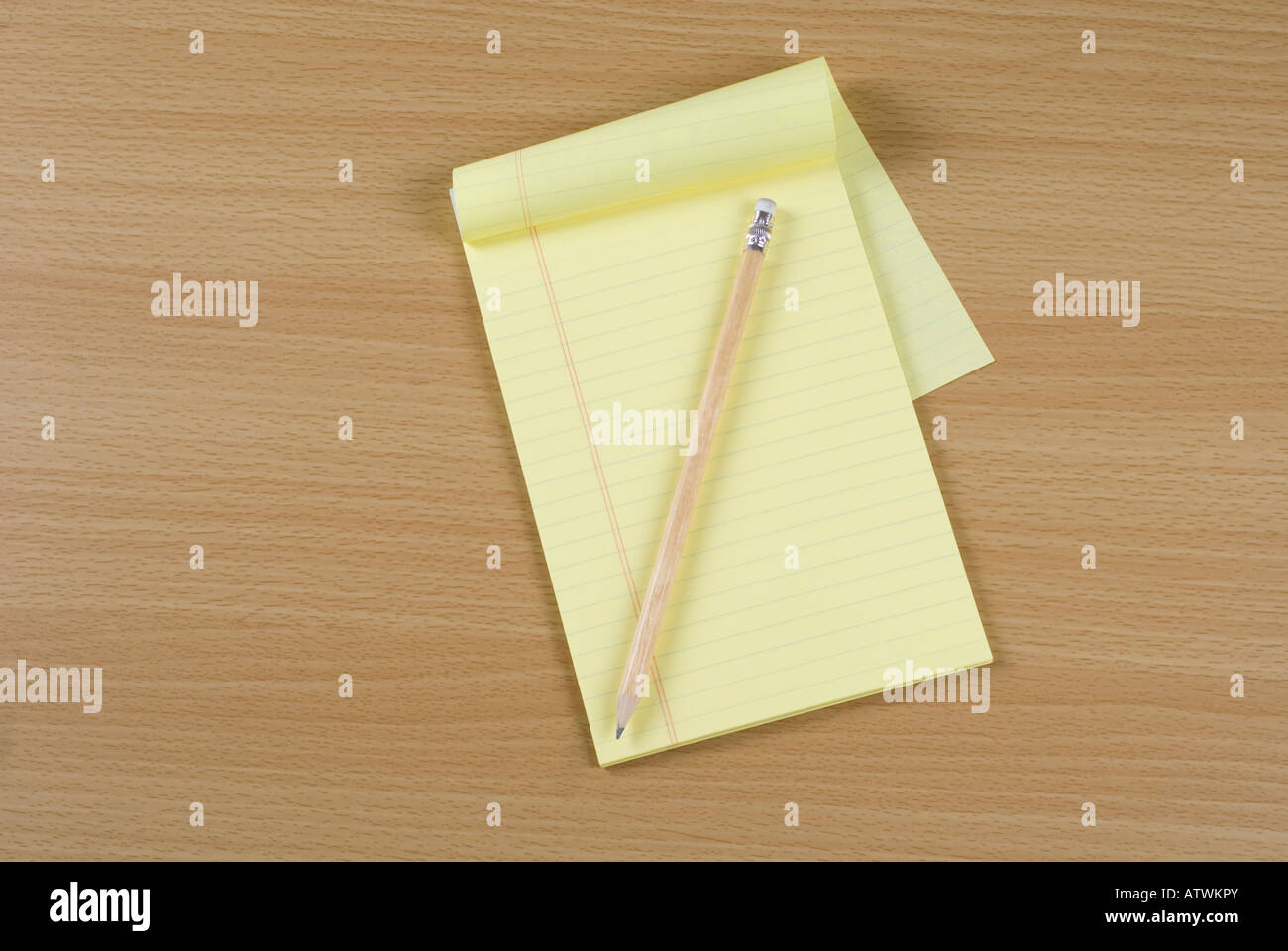Yellow notepad and a pencil Stock Photo - Alamy