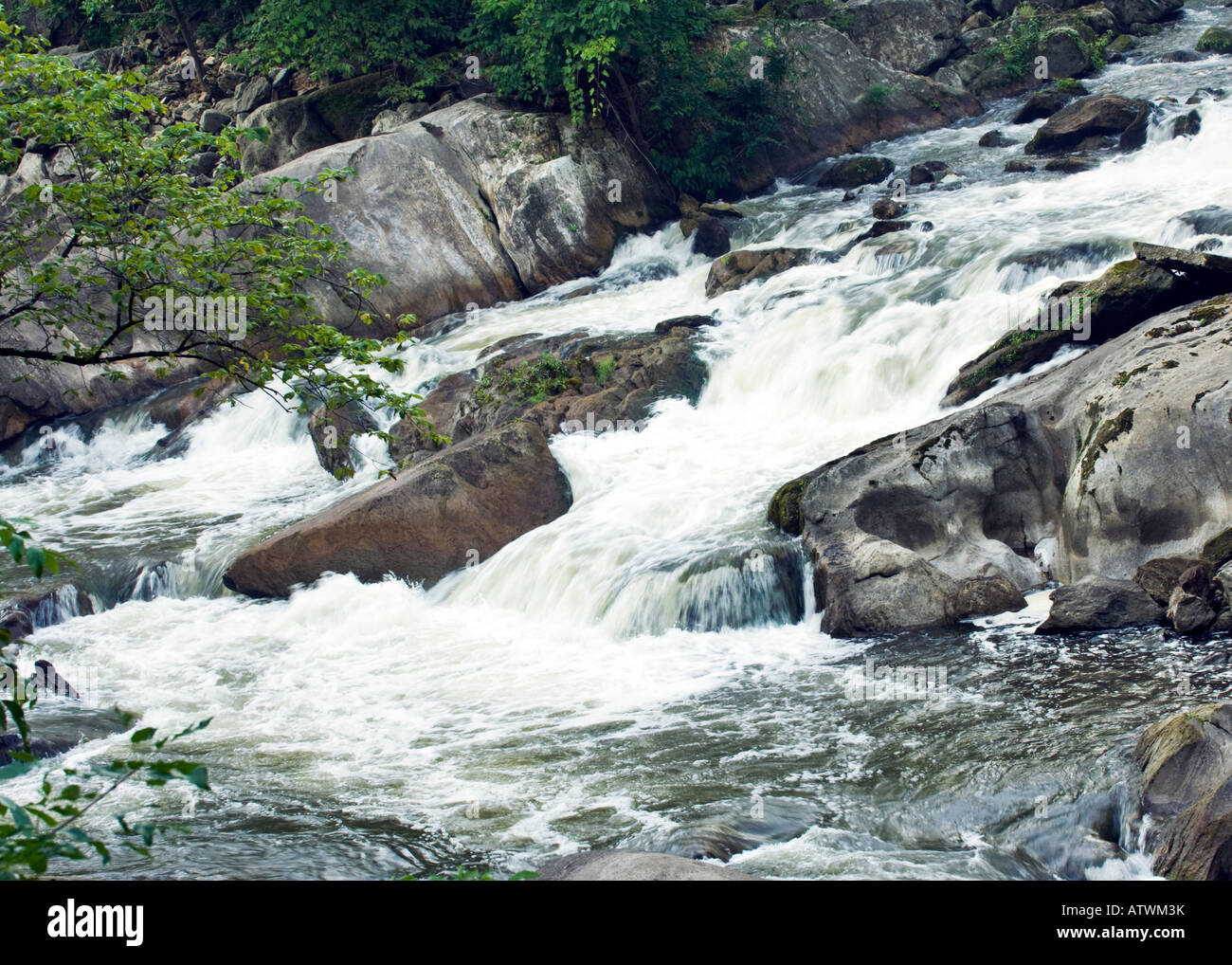 Rushing water spills over rocks Stock Photo - Alamy