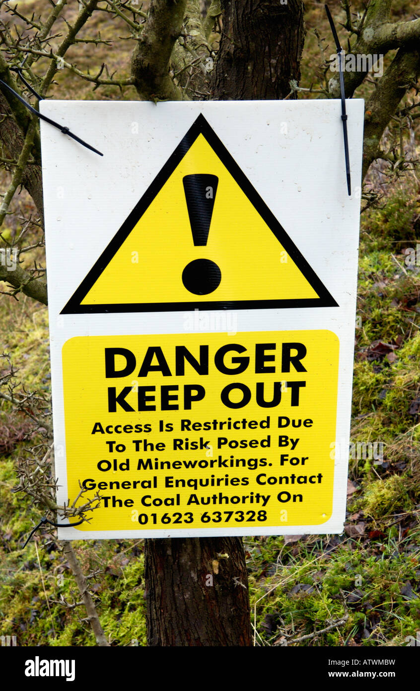 DANGER KEEP OUT sign at collapsed mineshaft on development land at Hoel ...