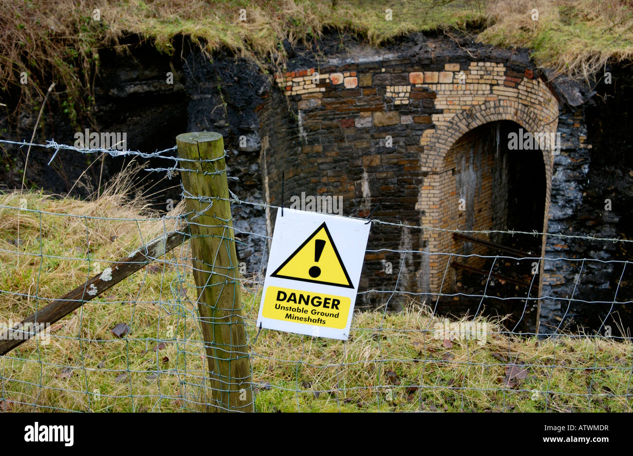 DANGER KEEP OUT sign at collapsed mineshaft on development land at Hoel ...