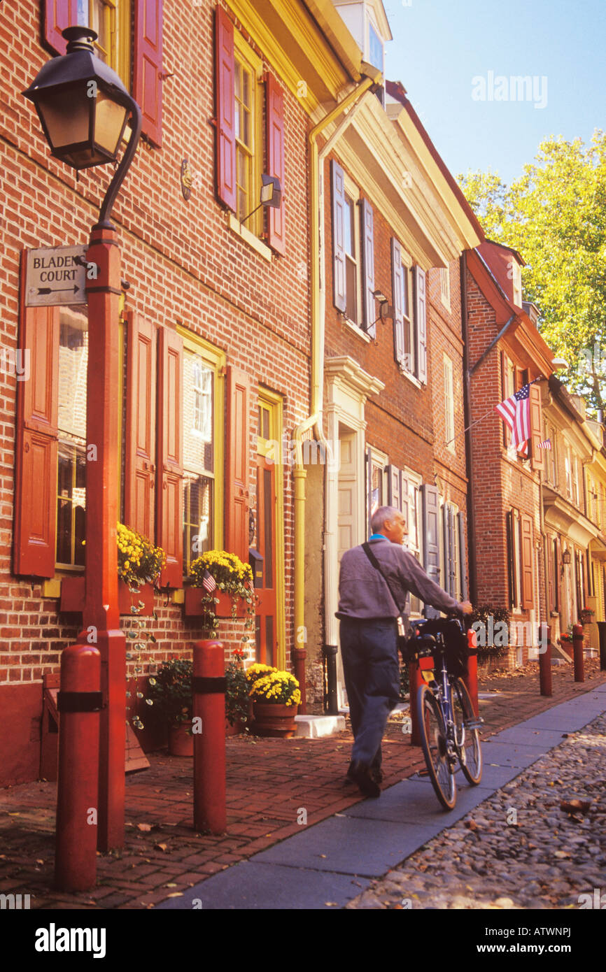 a visitor views the Colonial homes along Elfreths Alley Philadelphia ...