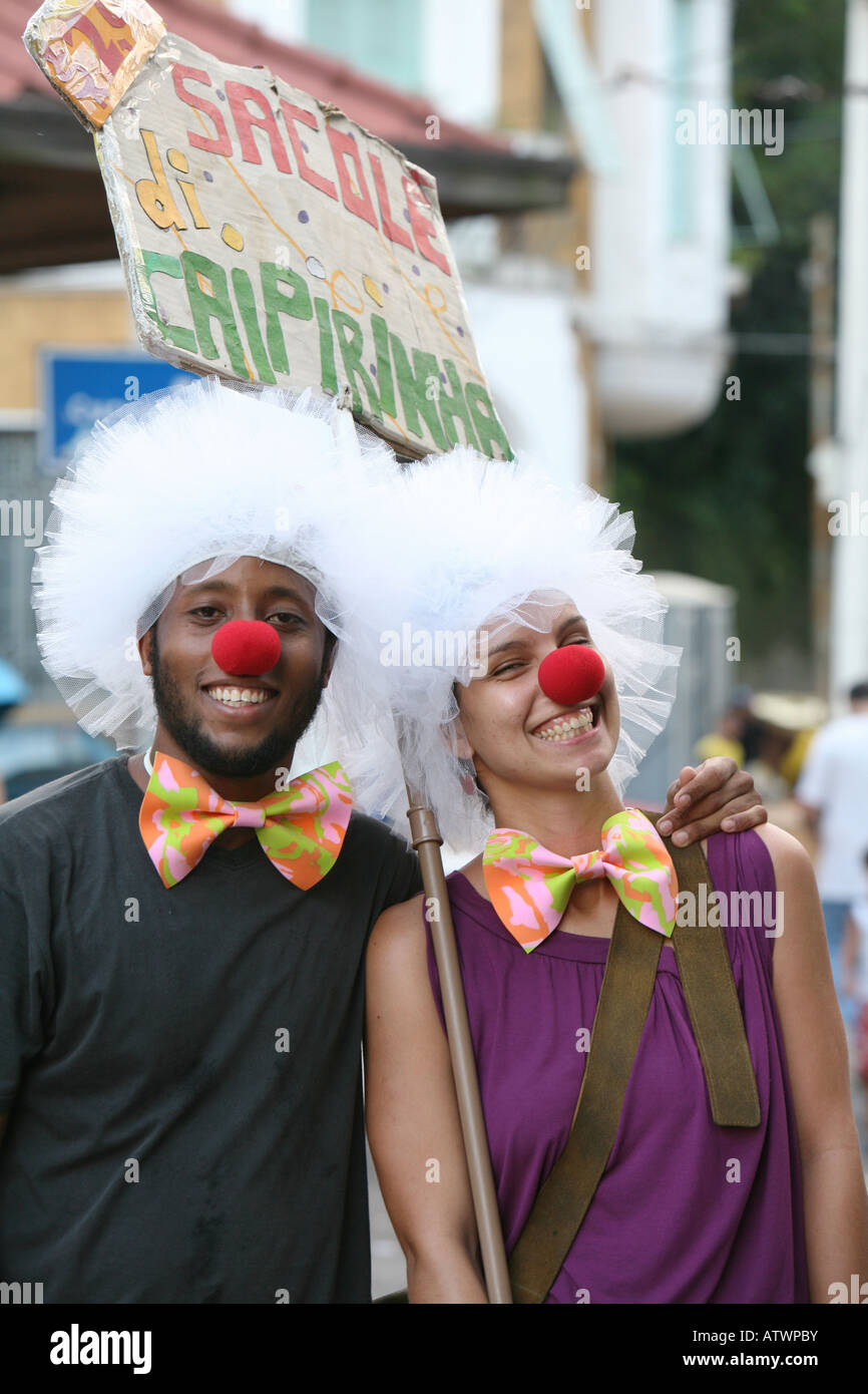 Portrait couple in white wig red nose costume in street carnival bloco ...