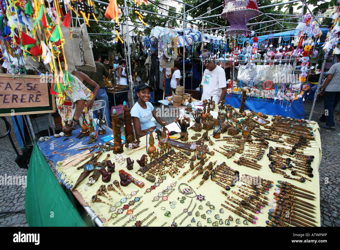 Stall lady shows off costume jewellery and carvings in street market ...