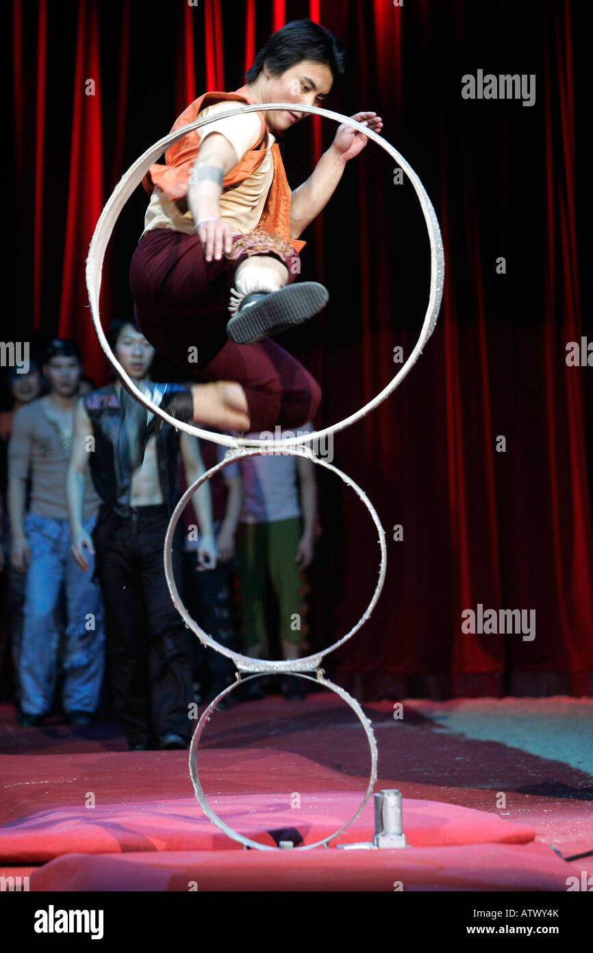 An artist of the group "Hoops" jumps through a hoop Stock Photo - Alamy