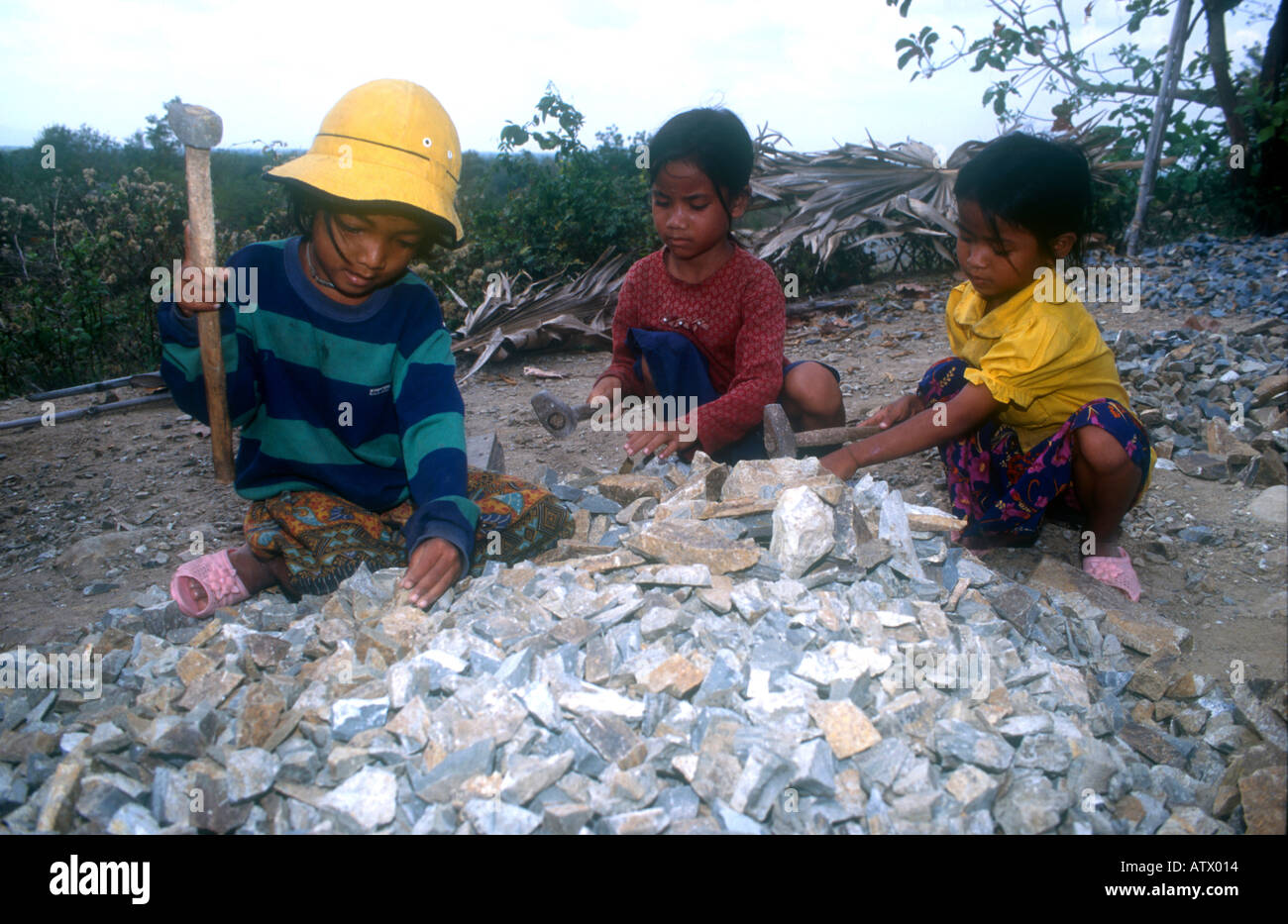 Child labourers work in a quarry breaking stones to build roads. Takeo ...