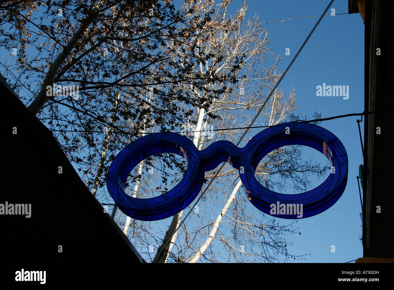 blue neon spectacles sign Stock Photo - Alamy