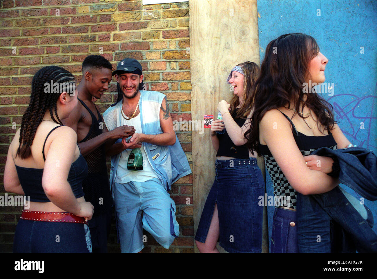 Group of young people hanging around street Stock Photo - Alamy