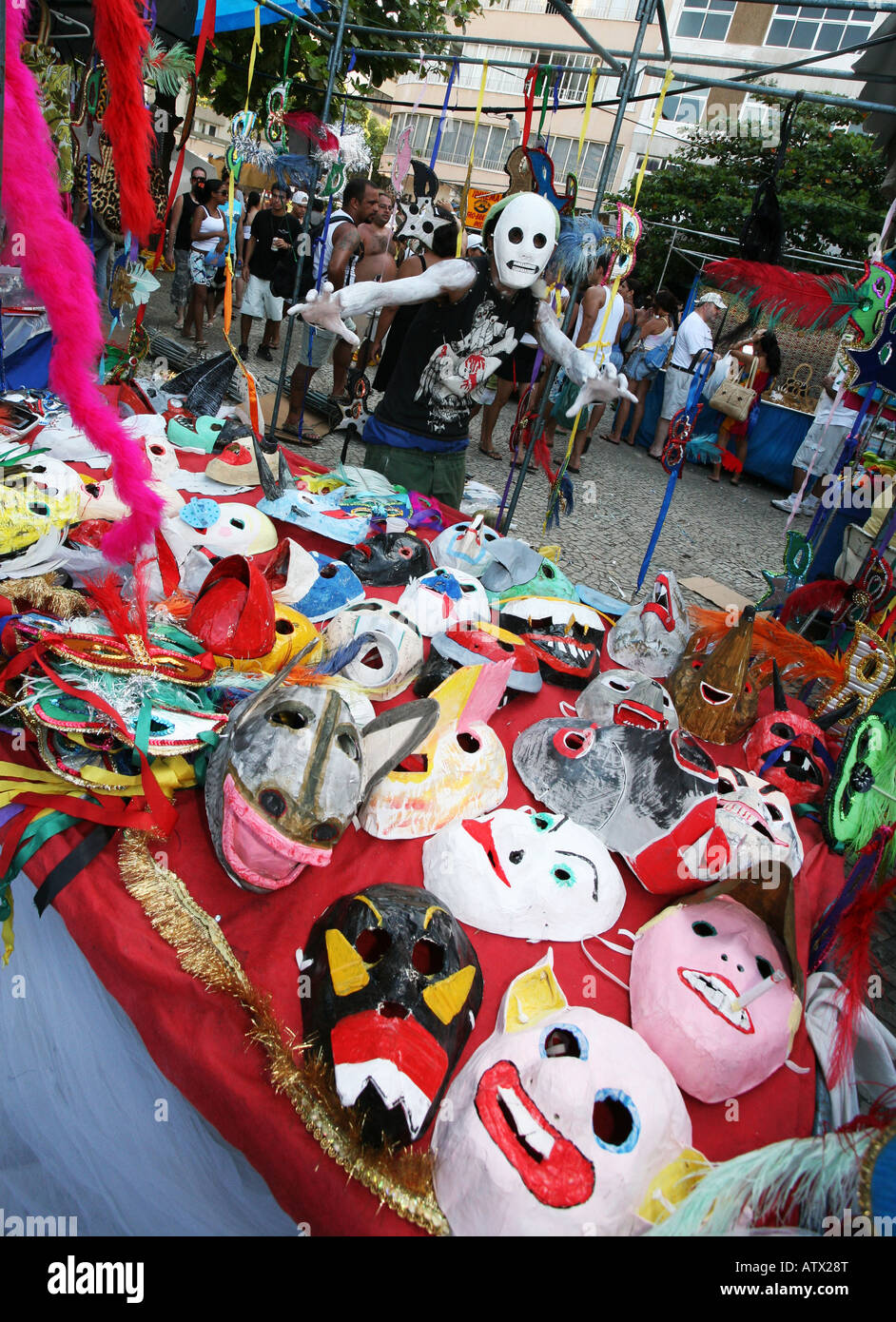Man wearing skull mask shows off masks for sale in street market ...