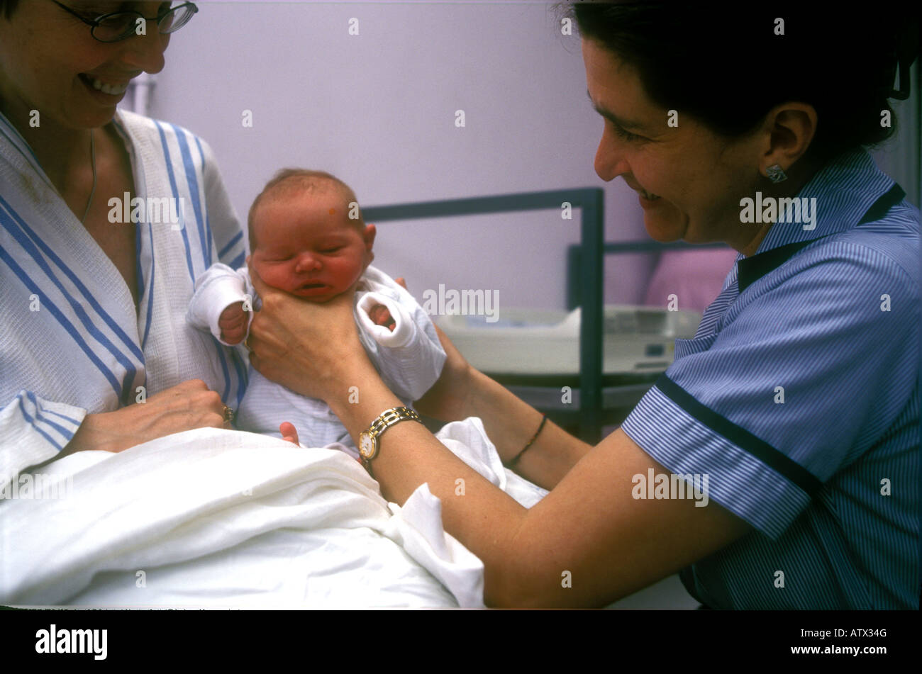 Midwife checking new born baby in post natal ward Stock Photo - Alamy
