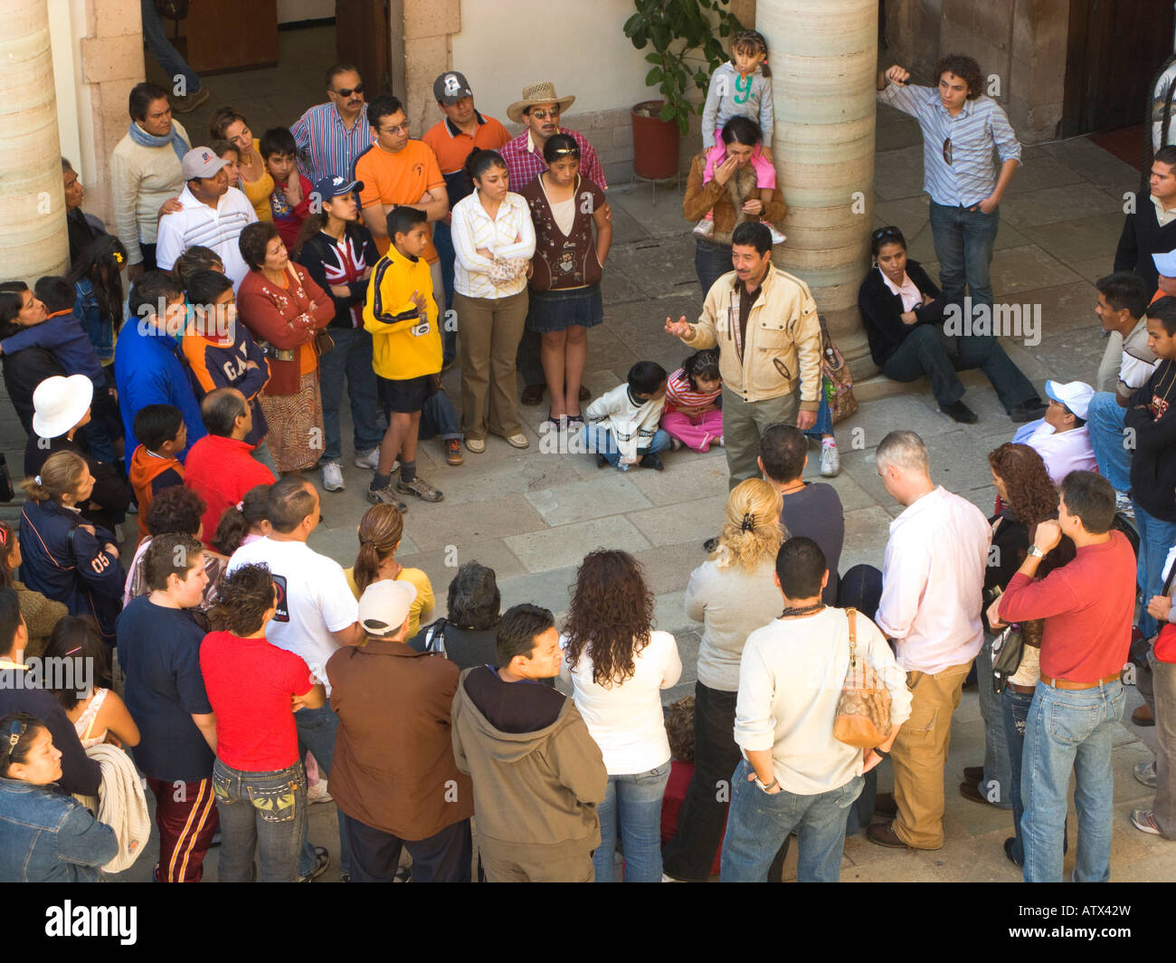 MEXICO Guanajuato Tour guide surrounded by large group of museum ...