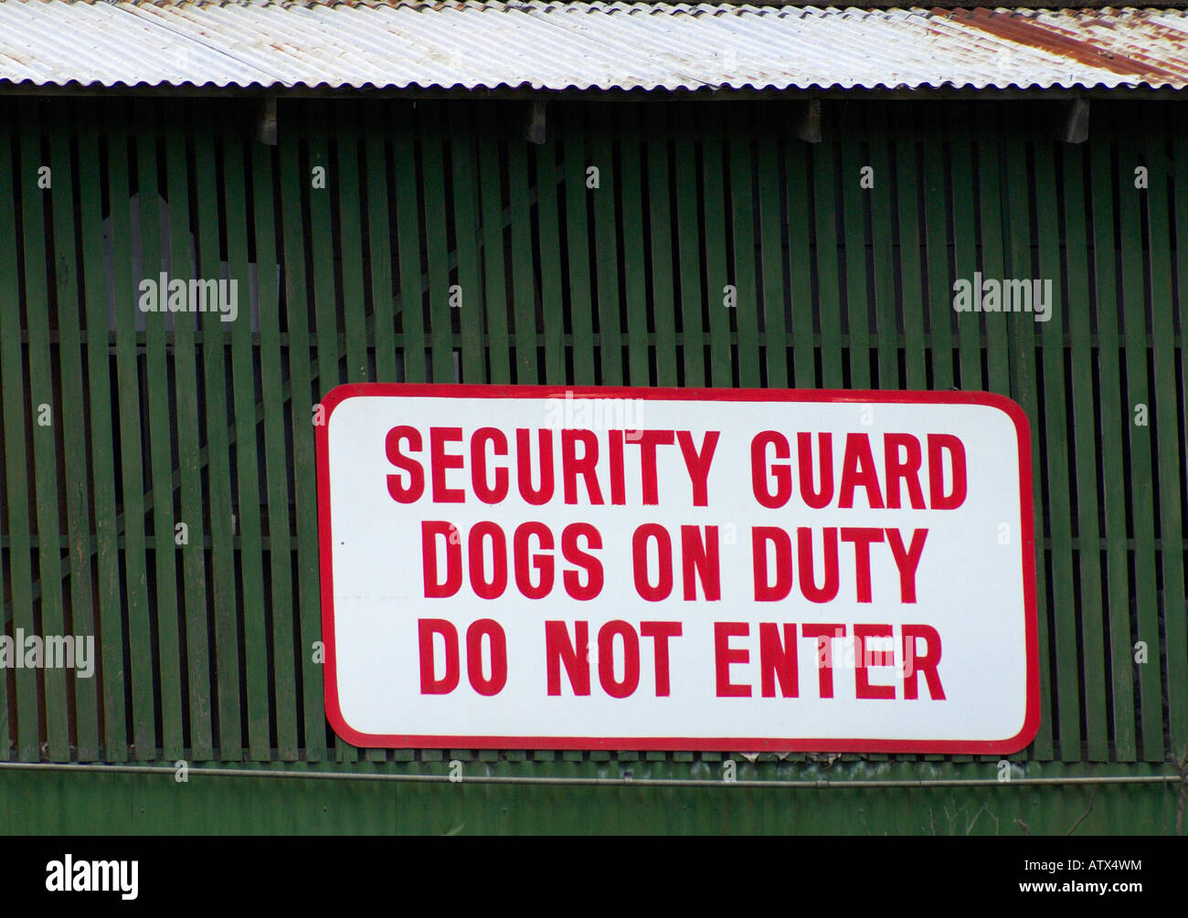 A warning sign on a building Stock Photo - Alamy