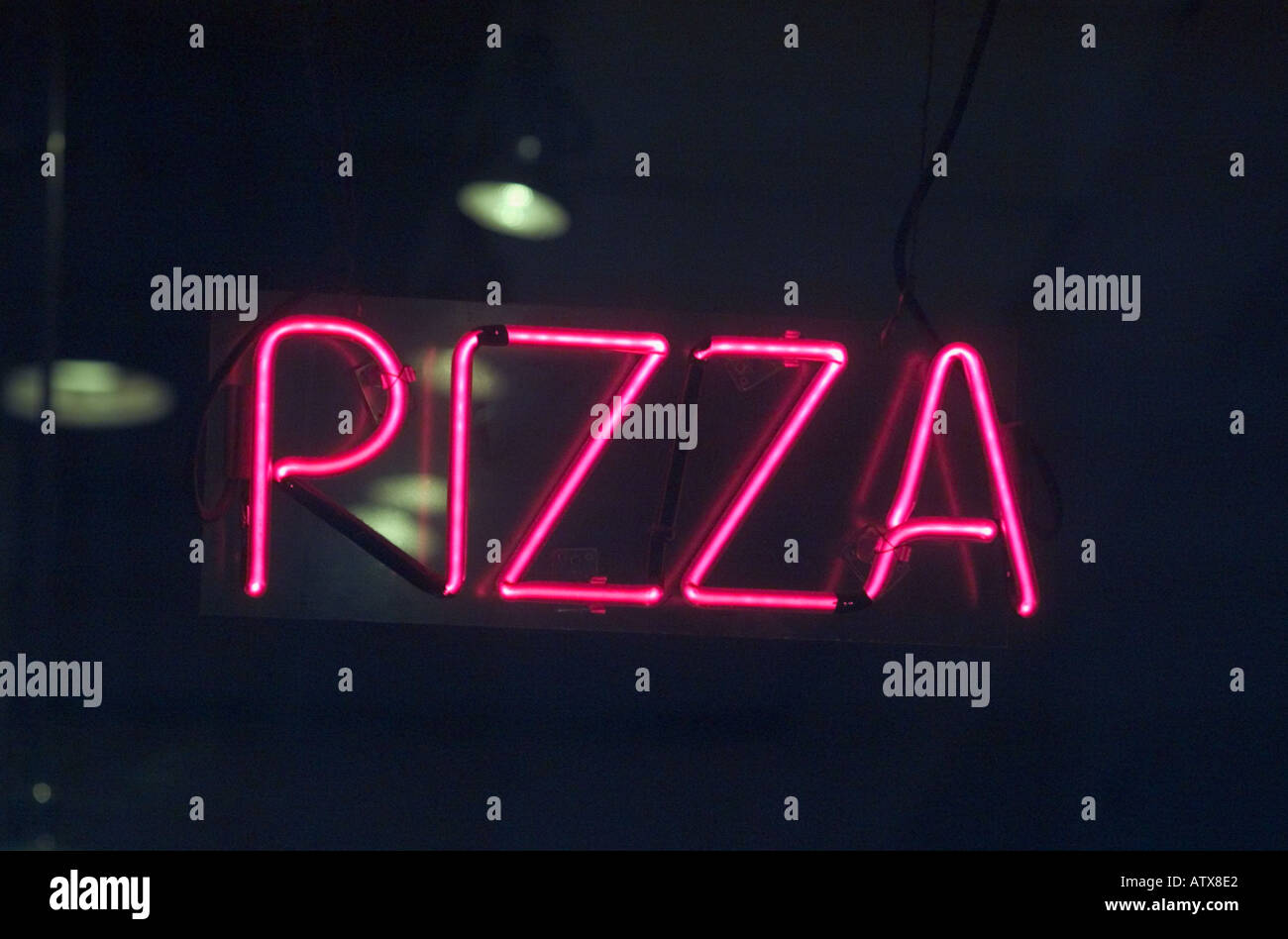 Still life of a Neon pizza sign in restaurant window Stock Photo - Alamy
