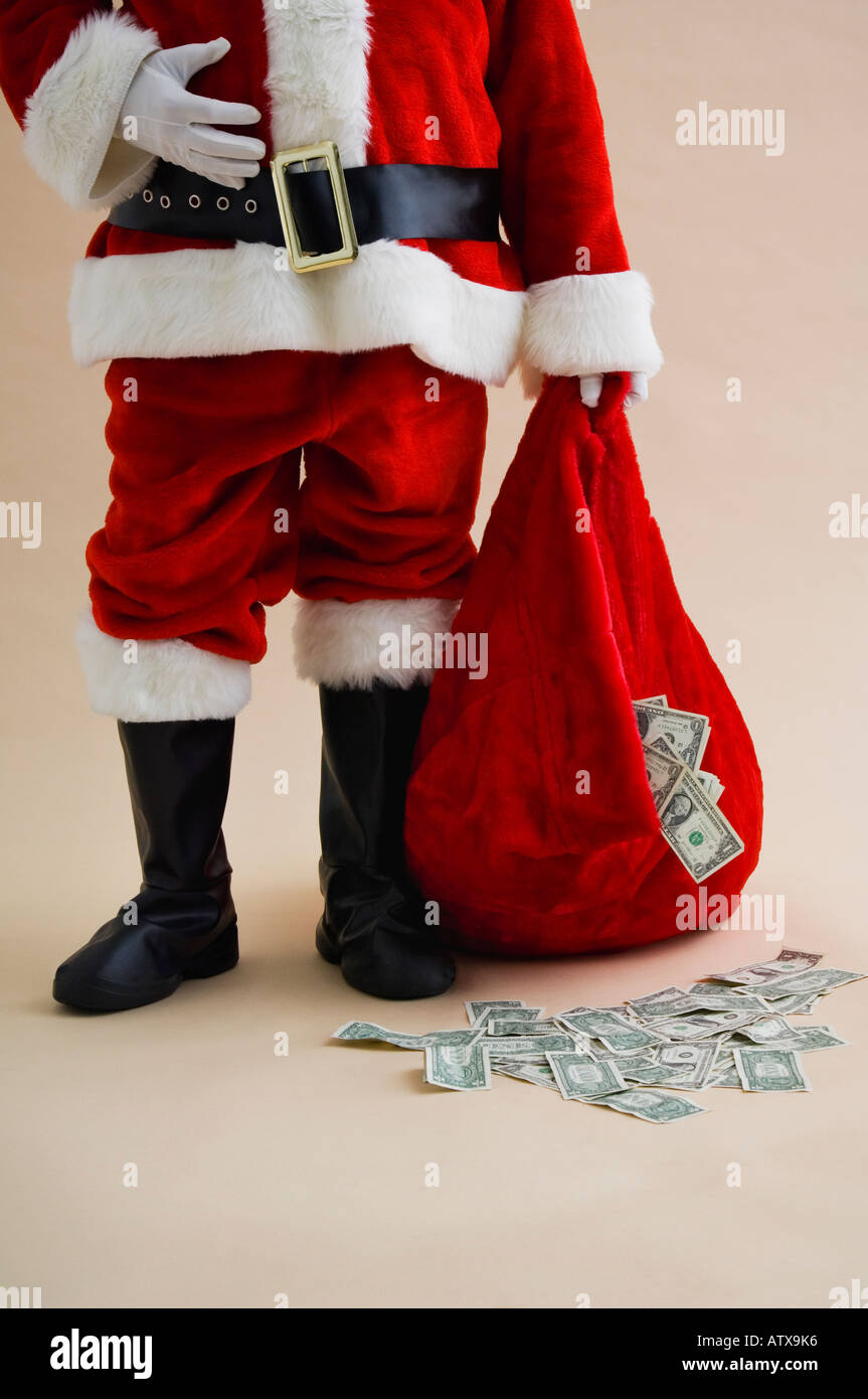 Santa with bag of money Stock Photo - Alamy