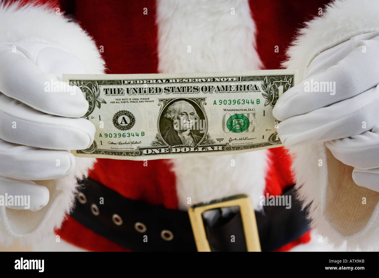Santa holding money Stock Photo - Alamy
