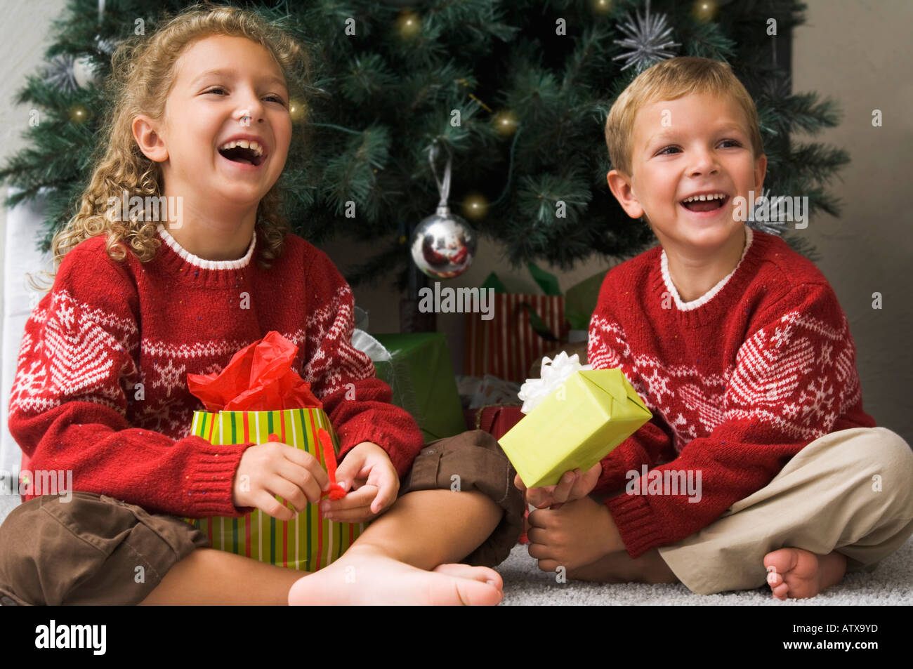 Children opening Christmas gifts Stock Photo - Alamy