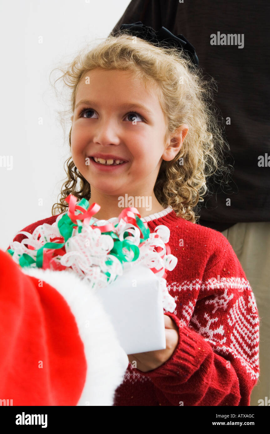 Girl getting gift from Santa Stock Photo - Alamy