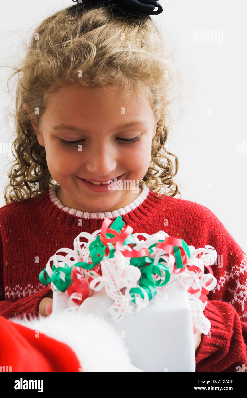 Girl getting gift from Santa Stock Photo - Alamy