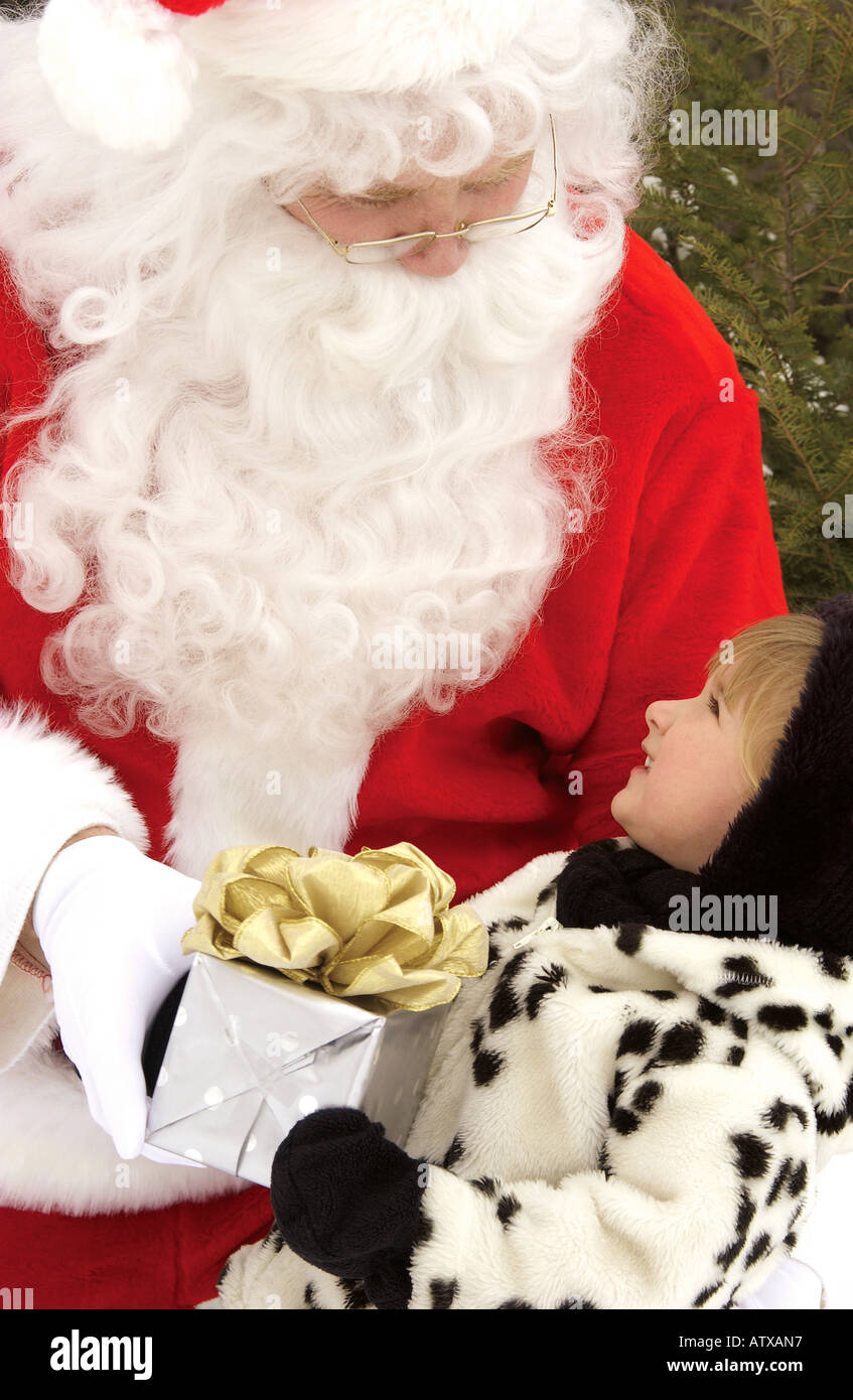 Girl getting gift from Santa Stock Photo - Alamy
