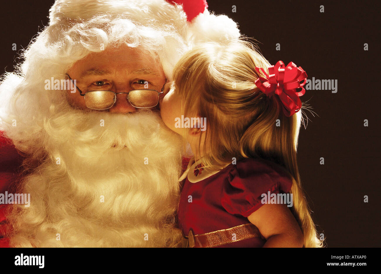 Girl kissing Santa Stock Photo - Alamy