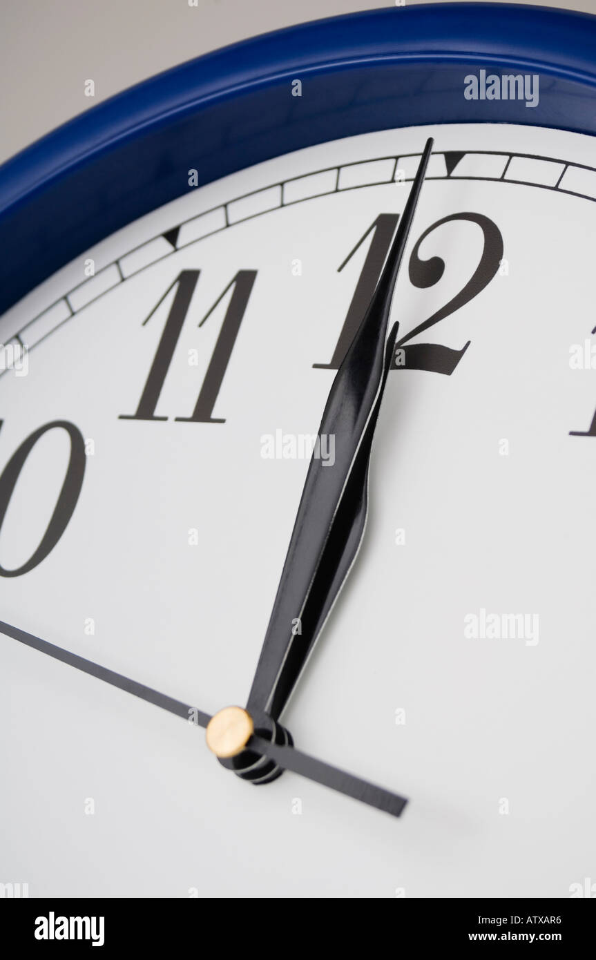 Clock turning midnight Stock Photo - Alamy