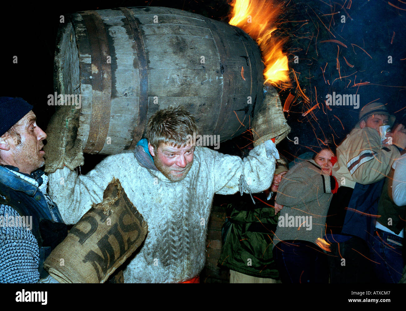 Tar Barrel Rolling at night through the streets of Ottery St Mary in ...