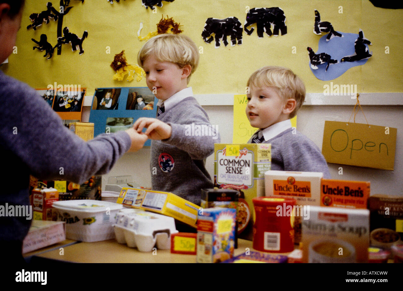 Primary school children acting out roles in shopping Stock Photo - Alamy