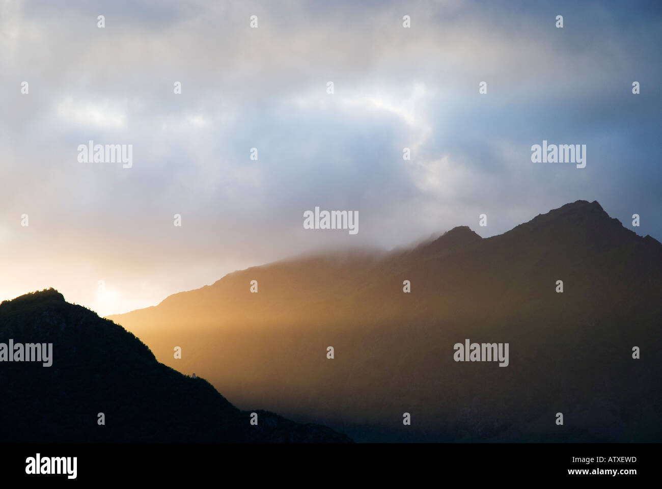 Sunset through mountains near village of Stamsund, Vestvågøy, Lofoten ...