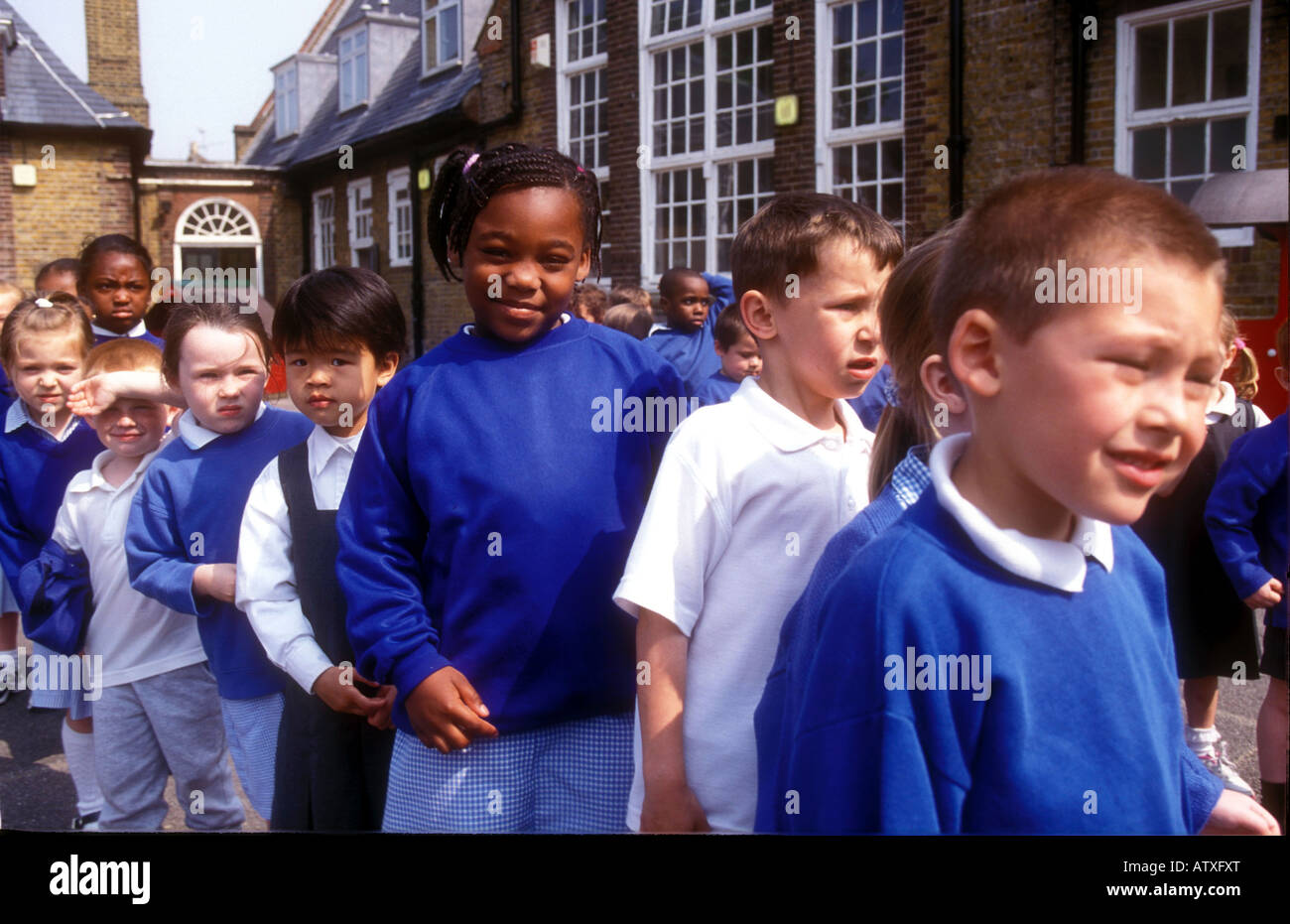 primary school children lining up in playground after break time Stock ...