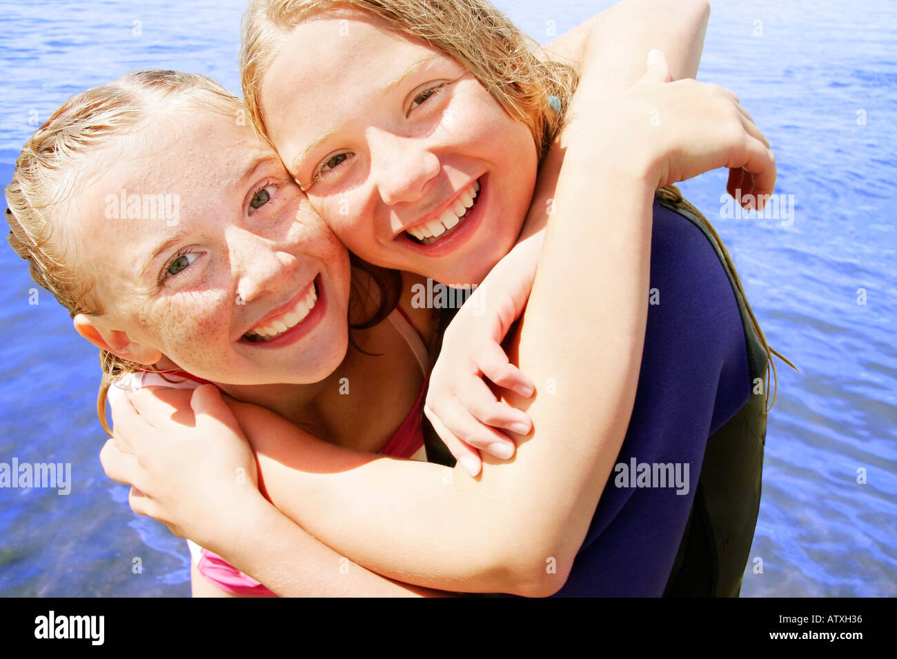 Two girls hug in the water Stock Photo - Alamy