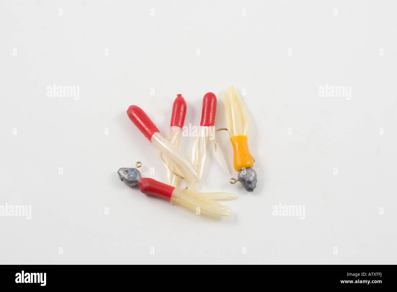 Small multicolored plastic fishing tube jigs commonly used for ...