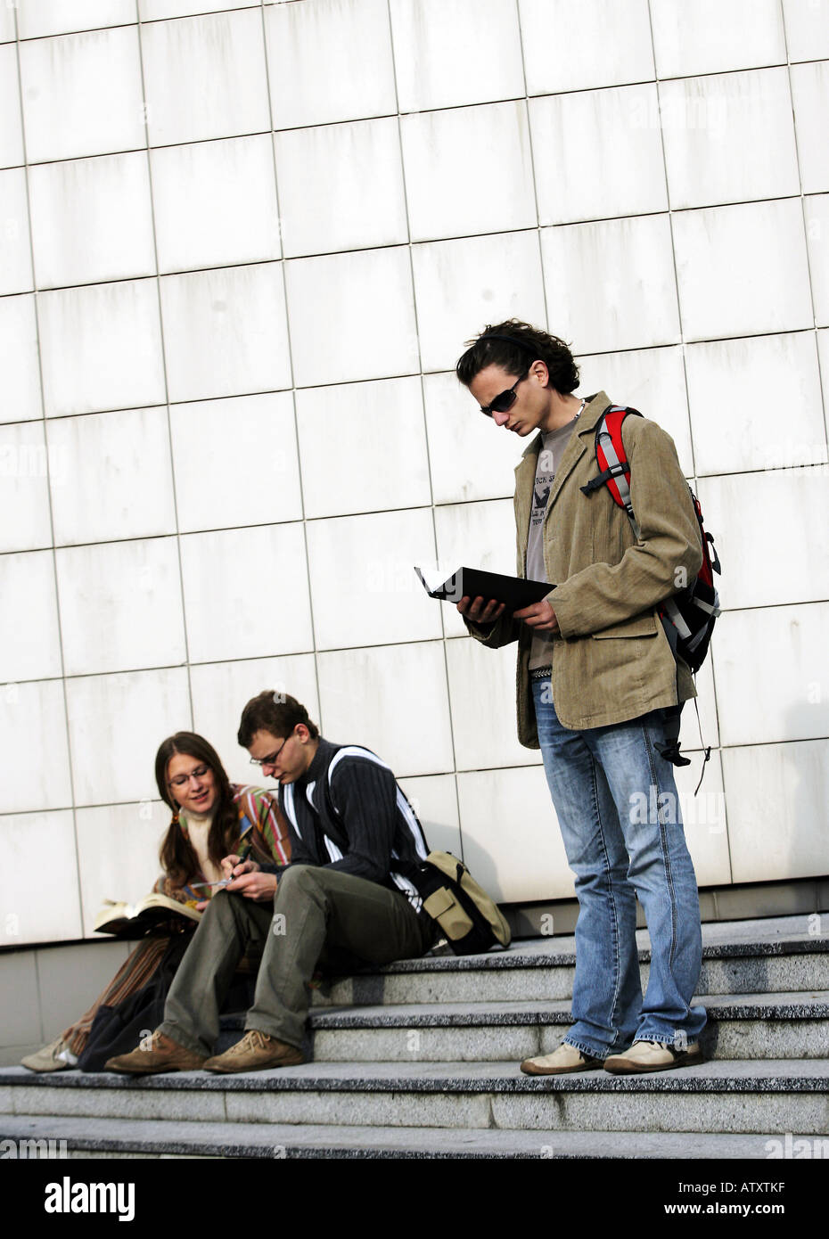 Two men sitting on stairs talking hi-res stock photography and images ...