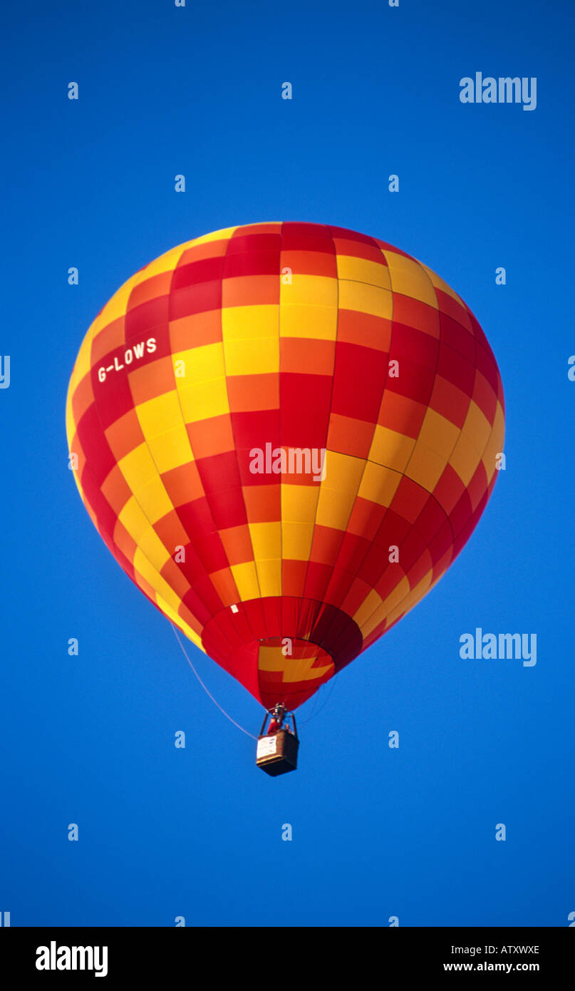 Yellow, red and orange checked hot air balloon Stock Photo - Alamy