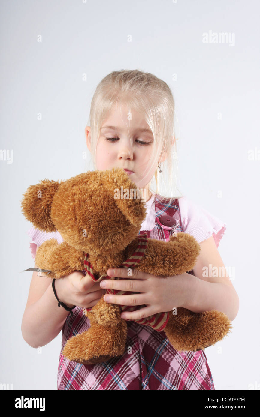 A little girl playing with her teddy bear Stock Photo - Alamy