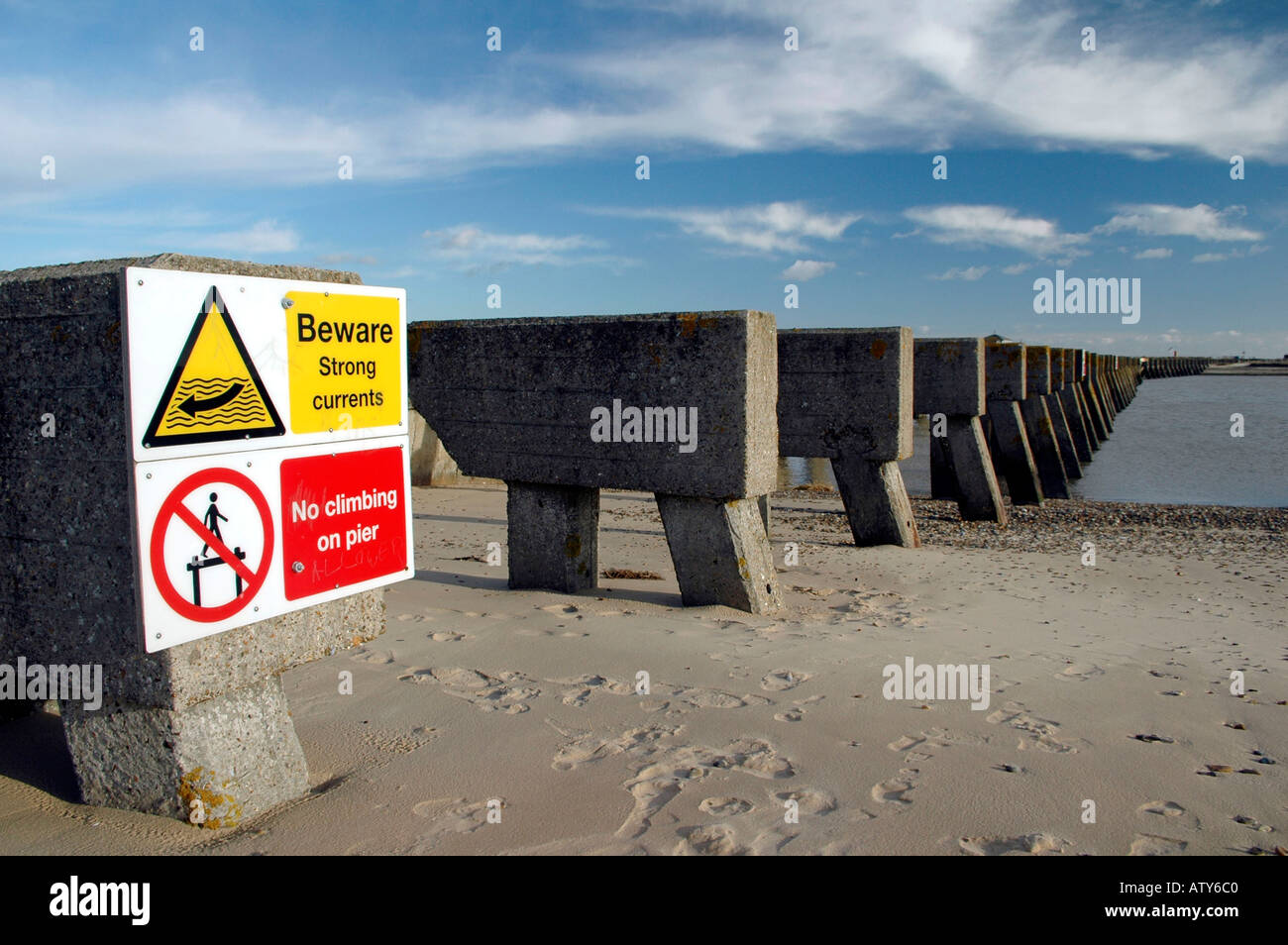 Warning signs on a concrete groyne Stock Photo - Alamy