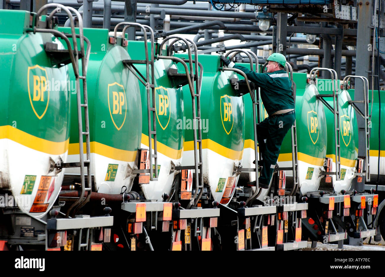 BP tanker lineup with man in green hard hat climbing access ladder at ...