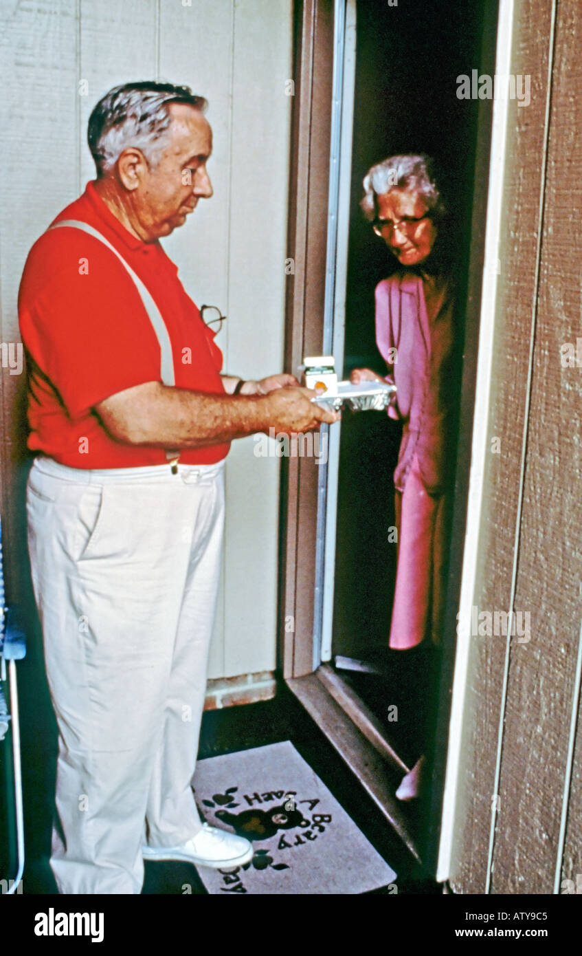 Meals on Wheels volunteer delivers meal to elderly shut in Stock Photo ...