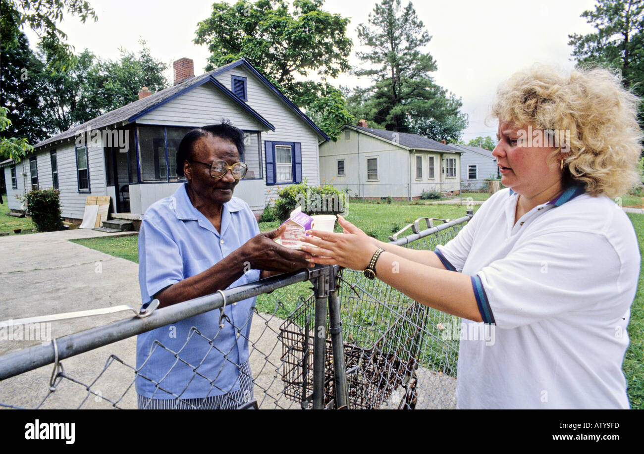 Meals on Wheels volunteer delivers meal to elderly shut in Stock Photo ...