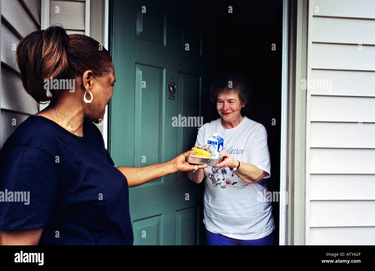 Meals on Wheels volunteer delivers meal to elderly shut in Stock Photo ...